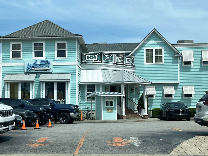 The seafoam-green exterior of Waterman's stands out like a cheerful beacon on Virginia Beach's oceanfront, promising coastal charm and seafood treasures within.