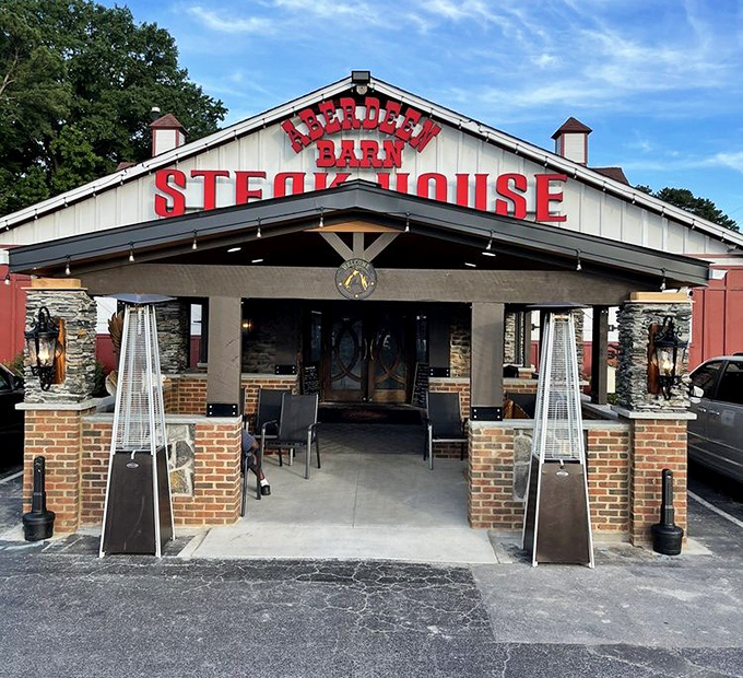 The iconic blue barn with bold red lettering announces your arrival at meat paradise. No trendy minimalism here&mdash;just the promise of serious steak.