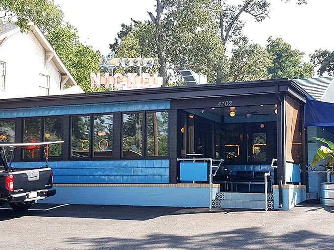 Little Nickel's corrugated metal exterior hides a tropical paradise within, like finding a secret tiki bar behind the hardware store.