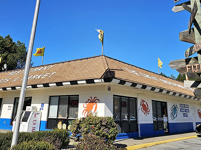 The unassuming exterior of The Great Machipongo Clam Shack stands like a seafood lighthouse, beckoning hungry travelers with its colorful crab murals and no-nonsense charm.