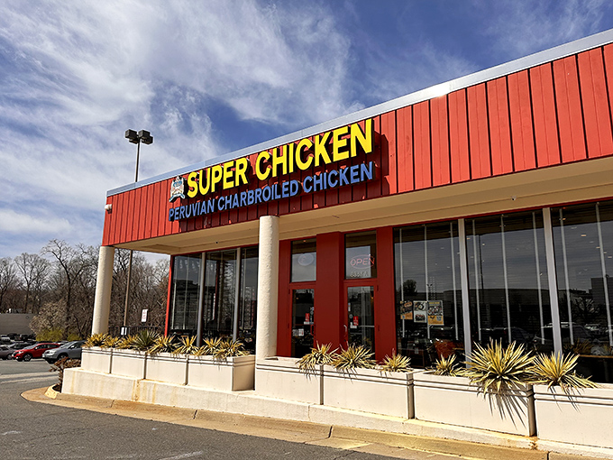 The crimson facade of Super Chicken stands out like a beacon of culinary promise in Vienna's retail landscape. Peruvian rotisserie excellence awaits inside.
