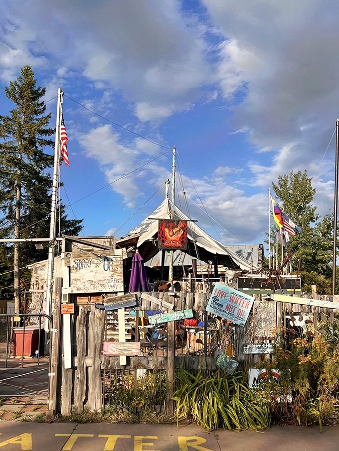 Not your average entrance! Tom's Burned Down Cafe embraces its phoenix-from-the-ashes origin story with a gloriously ramshackle facade that screams "adventure inside."