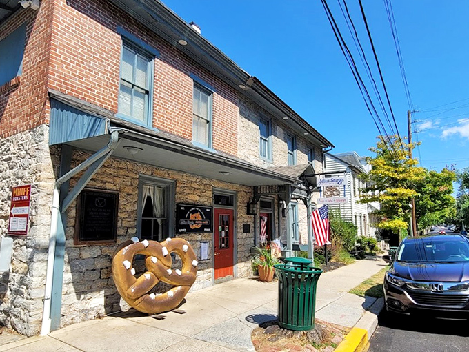 The historic stone and brick facade of Julius Sturgis Pretzel Bakery stands as a testament to American ingenuity, complete with an oversized pretzel sculpture that practically beckons you inside.