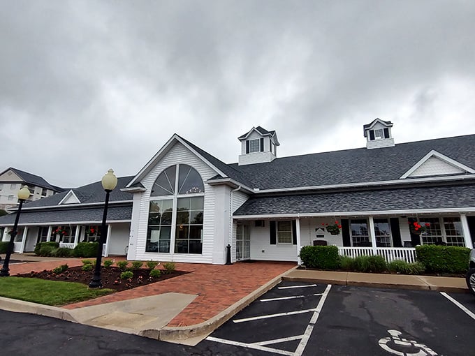 The classic white farmhouse exterior welcomes you like an old friend, promising comfort and satisfaction before you even step inside.