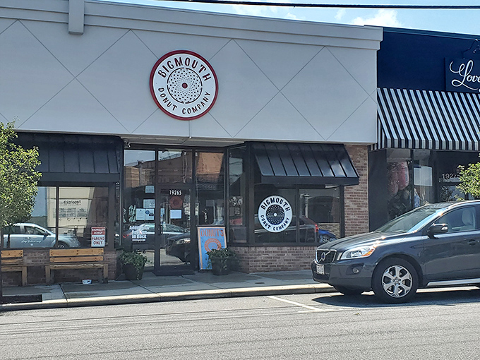 The unassuming storefront of Bigmouth Donut Company beckons with its clean white facade and distinctive circular logo&mdash;proof that donut paradise often hides in plain sight.