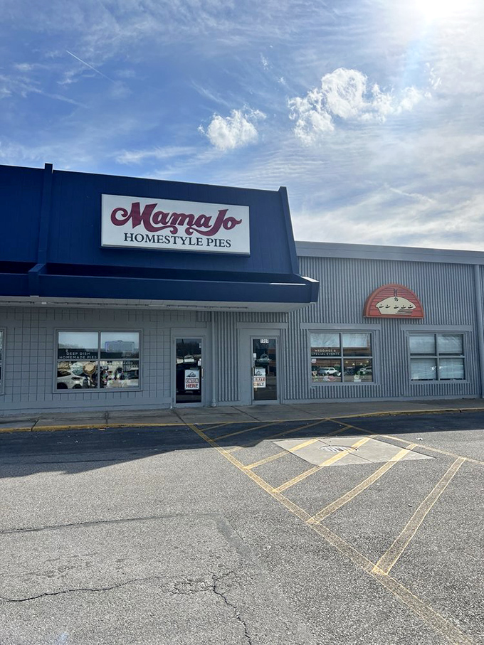 The blue awning and bold red script of Mama Jo's storefront promises pie paradise within—no fancy frills needed when the goods inside speak volumes.