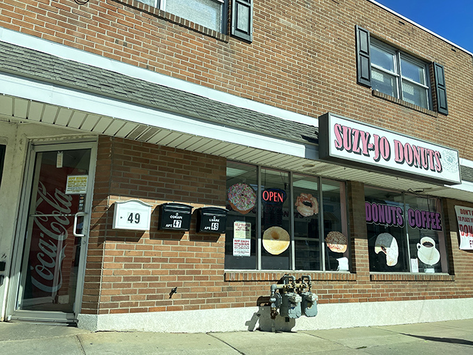 The pink signage of Suzy-Jo Donuts beckons like a sugary lighthouse on Bridgeport's main drag, promising sweet salvation to the donut-deprived.