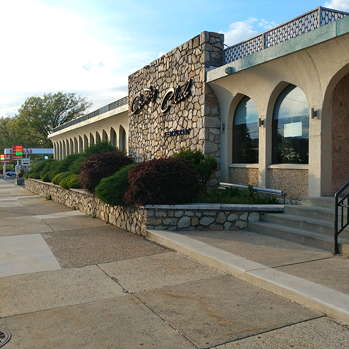 The iconic stone facade of Country Club Diner welcomes hungry Philadelphians with its elegant script signage and meticulously maintained landscaping.