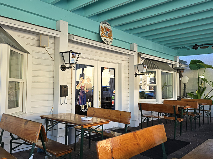 The teal-trimmed facade of The Bavarian Haus stands like a cheerful Alpine postcard against Florida's blue skies, promising authentic German flavors in Mount Dora.
