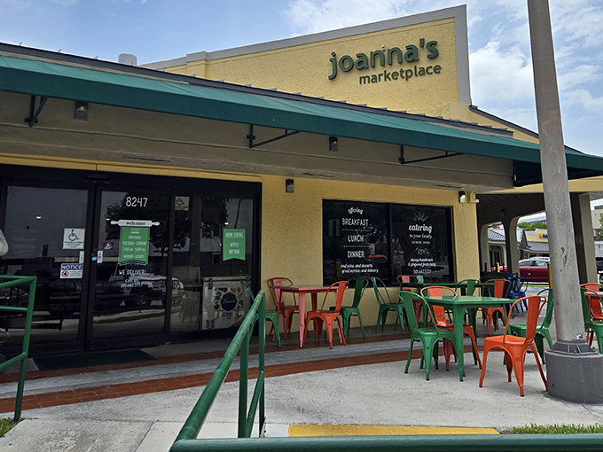 The cheerful yellow exterior of Joanna's Marketplace beckons like a culinary lighthouse, with those colorful chairs practically shouting, "Sit here and eat something wonderful!"