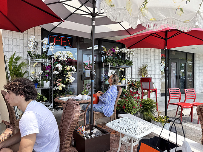 The Rooster's cheerful exterior with its vibrant red umbrellas is like a morning wake-up call that promises good things ahead.