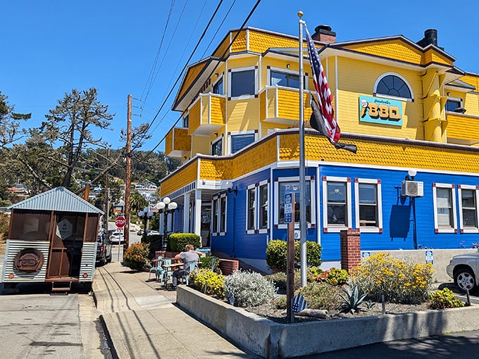 The unassuming exterior of Breakwater Barbecue hides in plain sight, with its smoker standing guard like a sentinel of savory promises to come.