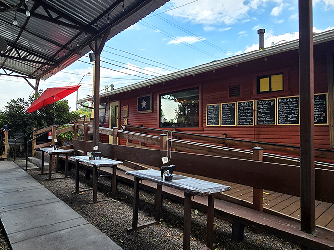 The rustic charm of Joey's exterior isn't trying to impress anyone—which is exactly why it does. Simple wooden benches under that iconic red umbrella promise authentic BBQ bliss.