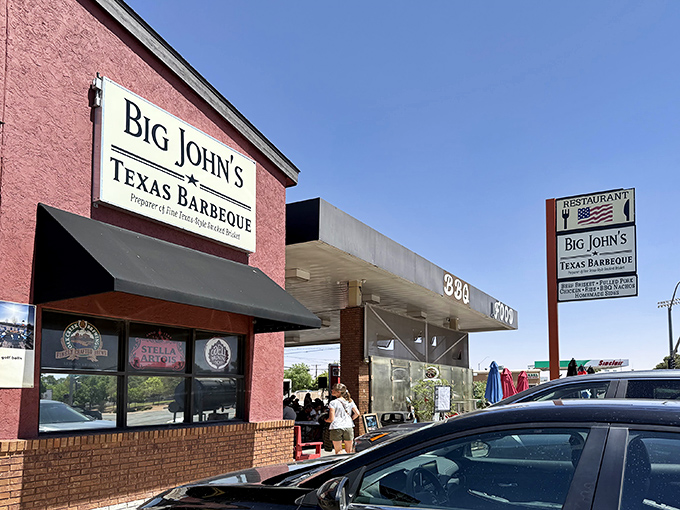 The unmistakable red exterior of Big John's Texas BBQ stands like a beacon for hungry travelers in Page, Arizona. BBQ paradise found!