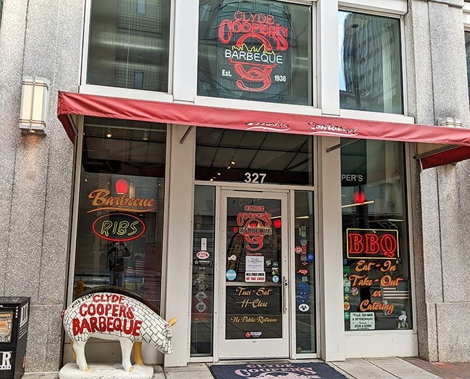 The iconic red awning and pig statue welcome you to Clyde Cooper's &ndash; where barbecue dreams come true since 1938.