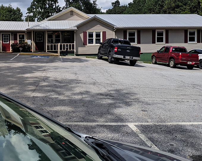 The unassuming front porch of Bar-H Barbecue proves once again that in Georgia, the most spectacular food often hides behind the most modest facades.