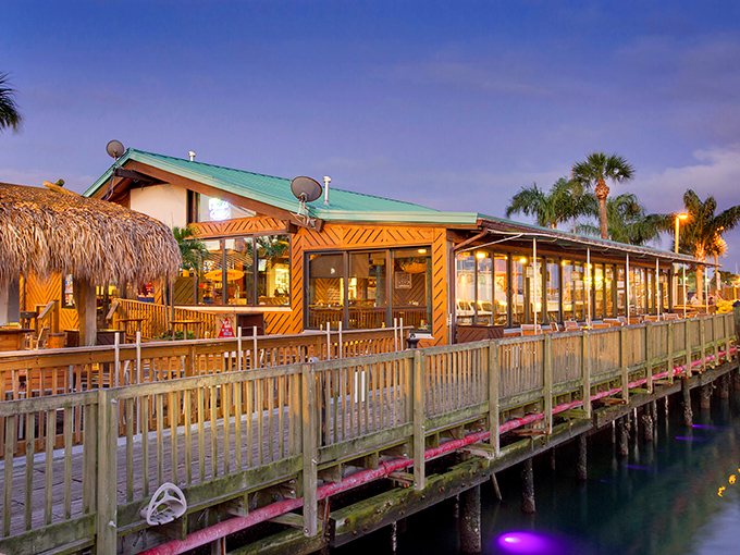 The neon glow of Grills beckons like a tropical lighthouse, promising seafood salvation after a day of Florida sun.