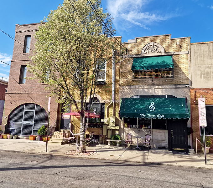 The iconic yellow brick fa&ccedil;ade of Victor Caf&eacute; stands proudly in South Philly, its green awnings like musical notes against the urban symphony.