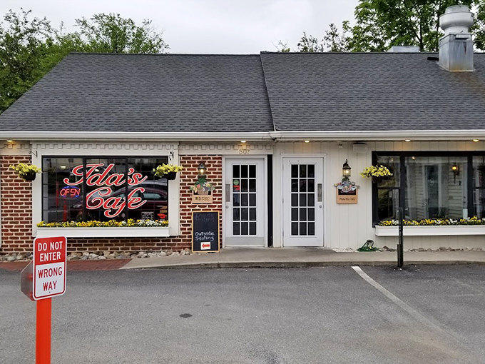 The orange accent wall of Ida's Caf&eacute; pops against the white brick like a breakfast beacon in Lancaster. Their neon sign promises delicious things await inside.