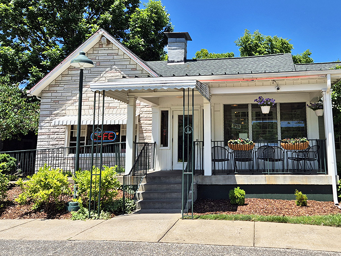 The charming exterior of Loveless Cafe welcomes visitors with its quaint porch and rustic barrel—Southern hospitality before you even step inside.