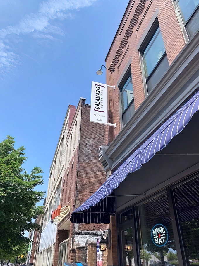 The brick facade of Calamari's Squid Row stands proudly against Erie's blue sky, a culinary lighthouse beckoning hungry travelers to its doorstep.