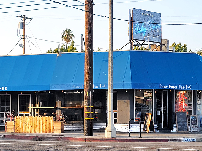 The blue awning of Baby Blues BBQ beckons like a smoky siren call to Venice Beach carnivores seeking refuge from kale smoothies.