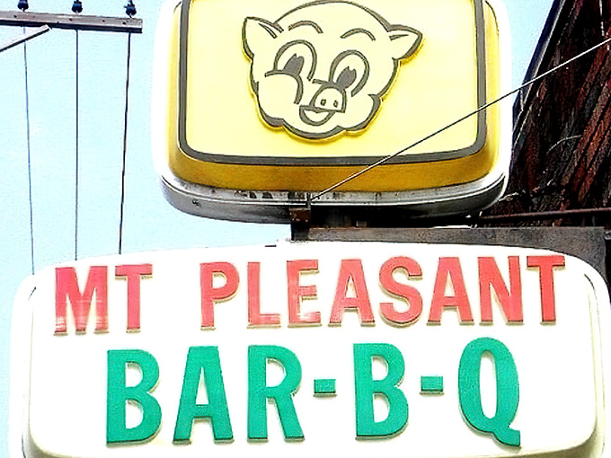 The unassuming storefront of MT Pleasant Bar-B-Q stands like a culinary lighthouse on Kinsman Road, beckoning hungry travelers with its vintage sign and promise of smoky delights.