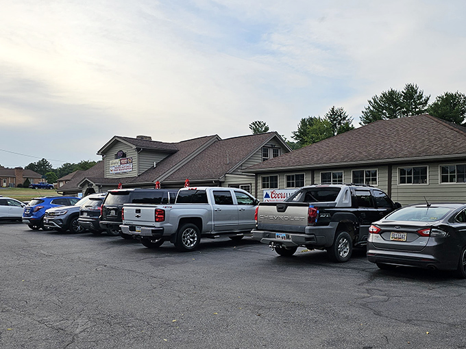 The rustic log cabin exterior isn't just charming—it's a siren call to hungry travelers. That parking lot tells the real story: people come from miles around.