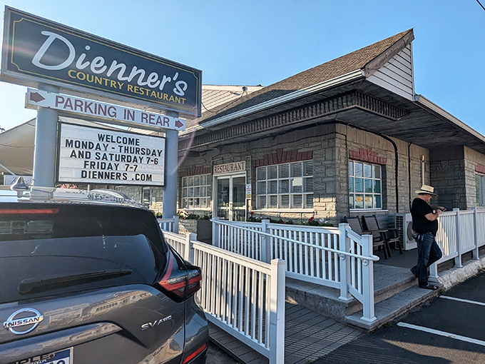 The unassuming exterior of Dienner's Country Restaurant beckons with its simple charm. Pennsylvania's best-kept secret hides behind that modest stone facade and white railing.