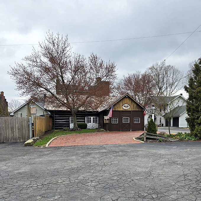 History stands proudly at the Spread Eagle Tavern, where the rustic log exterior and brick pathway whisper tales of stagecoach travelers and modern-day food pilgrims alike.