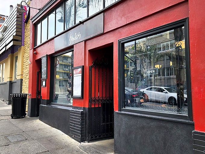 The vibrant red exterior of Brenda's stands out like a culinary beacon in San Francisco's Tenderloin district, promising Southern comfort with French flair.