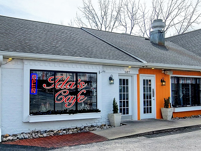 The orange accent wall of Ida's Caf&eacute; pops against the white brick like a breakfast beacon in Lancaster. Their neon sign promises delicious things await inside.