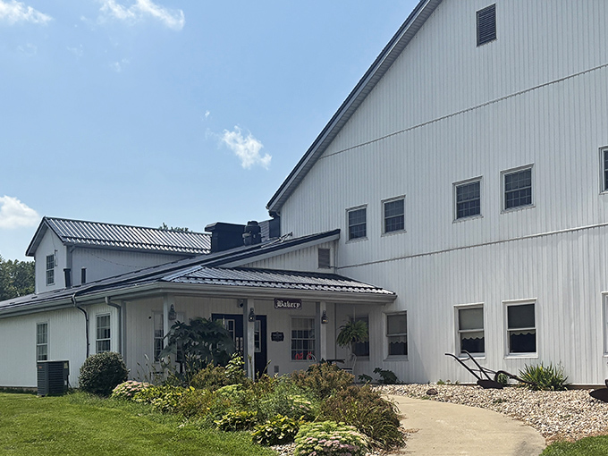 The pristine white exterior of Gasthof Amish Village welcomes visitors like a Norman Rockwell painting come to life, complete with charming lamp posts and a welcoming front porch. 
