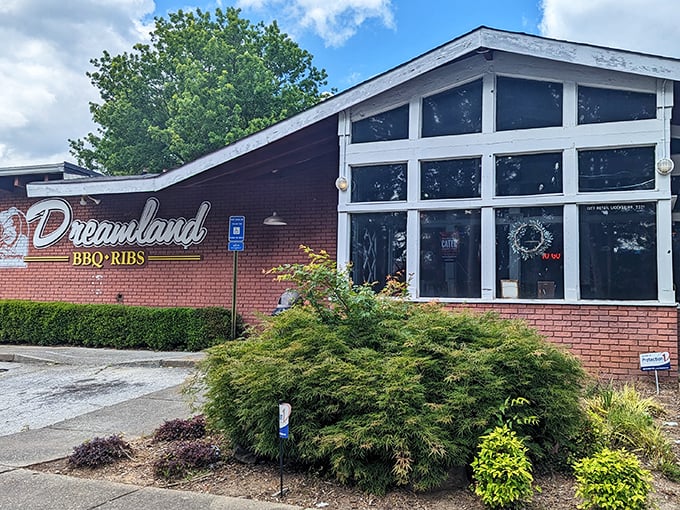 The brick fortress of flavor stands proud with its white-railed porch, like a barbecue beacon calling hungry souls to meat salvation.
