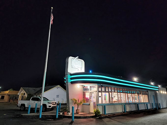 The neon glow of The Palace Diner beckons like a lighthouse for hungry souls. That turquoise trim against the night sky is pure roadside Americana magic.