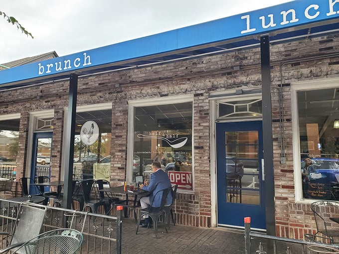 The exposed brick exterior of Half & Half beckons like an old friend, promising comfort and culinary delight behind that cheerful "OPEN" sign.