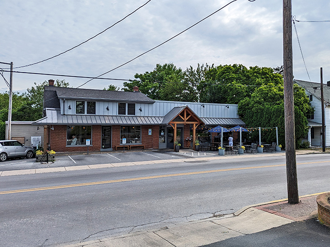 The blue exterior of Speckled Hen beckons like a culinary lighthouse on Strasburg's Main Street, complete with charming wooden accents and inviting outdoor seating.
