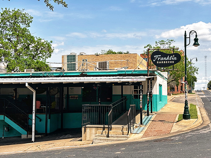 The unassuming turquoise exterior of Franklin Barbecue belies the culinary magic happening inside. Like a barbecue speakeasy, only the aroma gives away its secrets.