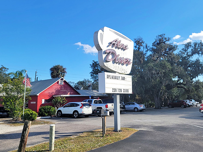 The iconic coffee cup sign stands tall against the Florida sky, beckoning hungry travelers to this unassuming red building that promises comfort food paradise.