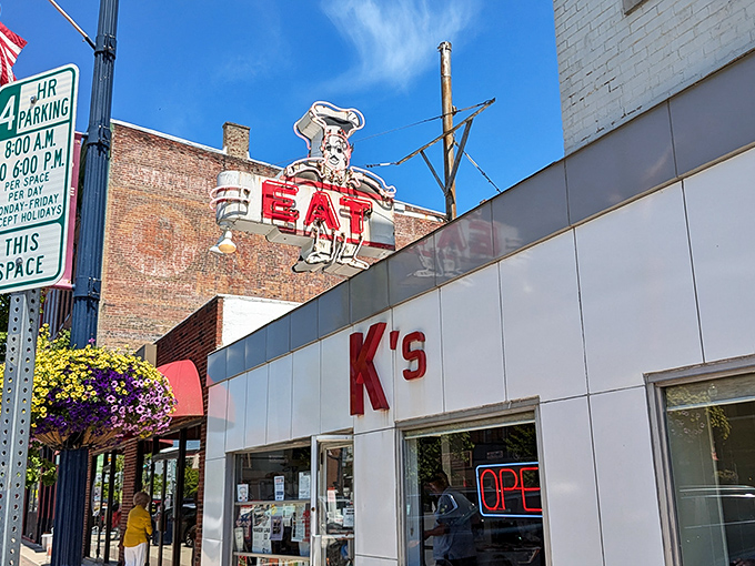 The unassuming white exterior of K's Hamburger Shop in Troy stands as a time capsule of Americana, complete with that classic neon sign that's been beckoning hungry travelers for generations.