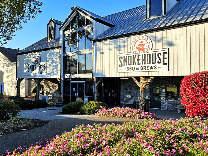 The barn-like exterior of Smokehouse BBQ & Brews stands proudly against a blue Pennsylvania sky, promising smoky delights within those timber walls.