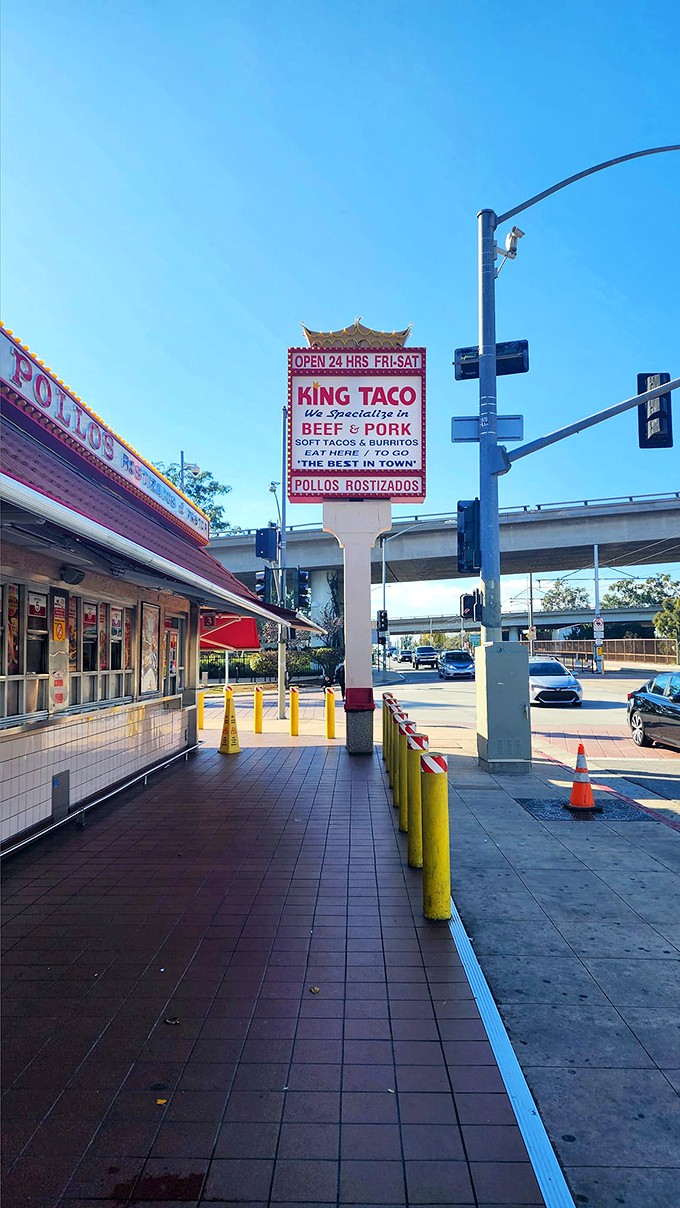 The iconic King Taco sign stands proud against the blue LA sky, promising culinary treasures that have kept locals coming back for decades.