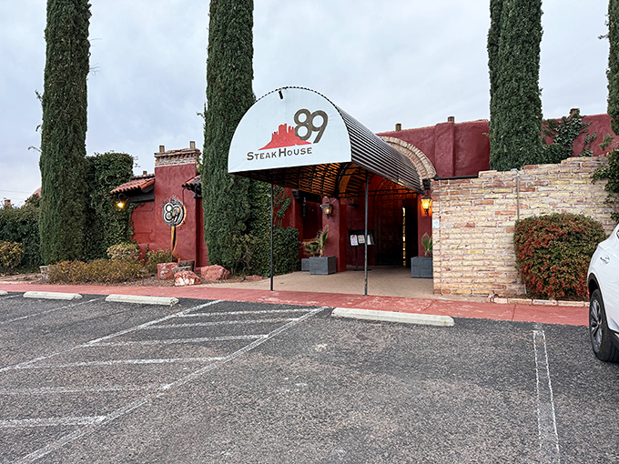 The terracotta fortress of flavor stands guard with cypress sentinels, promising carnivorous delights within Sedona's rustic-chic dining scene.