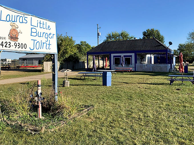 The blue-roofed burger sanctuary beckons from the roadside, promising simple pleasures that no fancy restaurant could ever replicate.