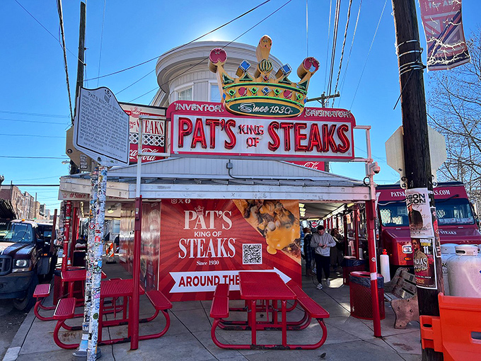 The crown jewel of South Philly! Pat's iconic sign glows like a neon North Star, guiding hungry pilgrims to the promised land of cheesesteak perfection.