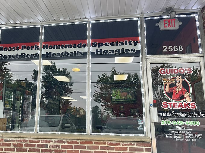 The unassuming storefront of Guido's promises culinary treasures within. Those red signs aren't just decoration&mdash;they're a roadmap to sandwich nirvana.
