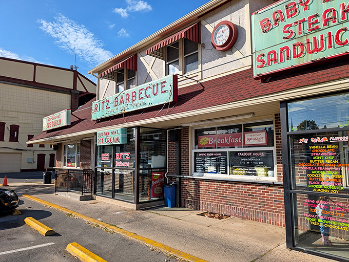 The vintage neon sign beckons like an old friend, promising comfort food treasures behind that unassuming brick facade. Culinary time travel starts here.