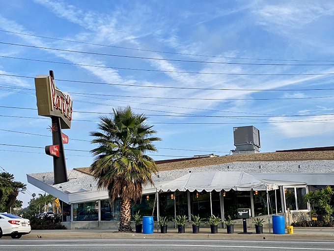 The unmistakable angular roof and neon sign of Pann's stands as a mid-century modern beacon, promising comfort food and nostalgia in equal measure.