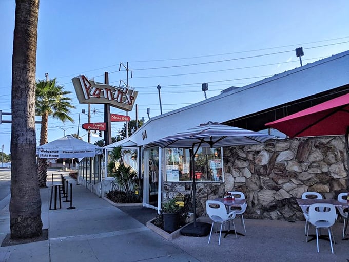 The iconic Pann's sign stands tall against the California sky, a neon beacon promising comfort food that's outlasted countless food trends.