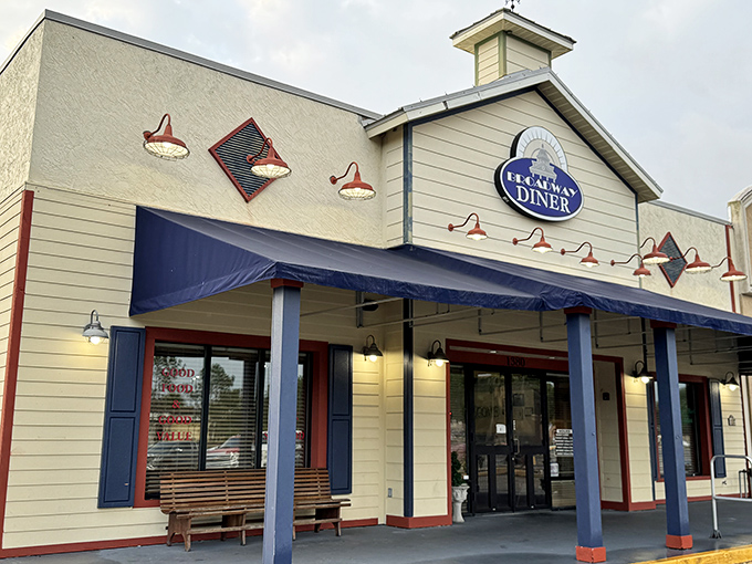 The classic cream exterior with navy blue awnings of Broadway Diner stands like a beacon of breakfast hope in Bartow, promising comfort food salvation inside.